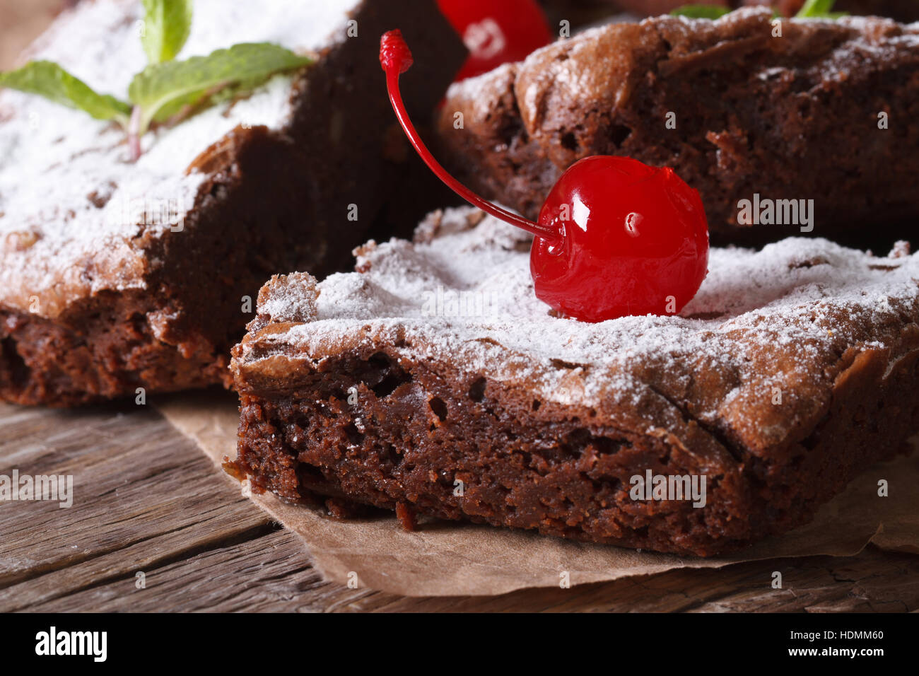 Delicious chocolate brownie cake with cherry closeup on paper ...