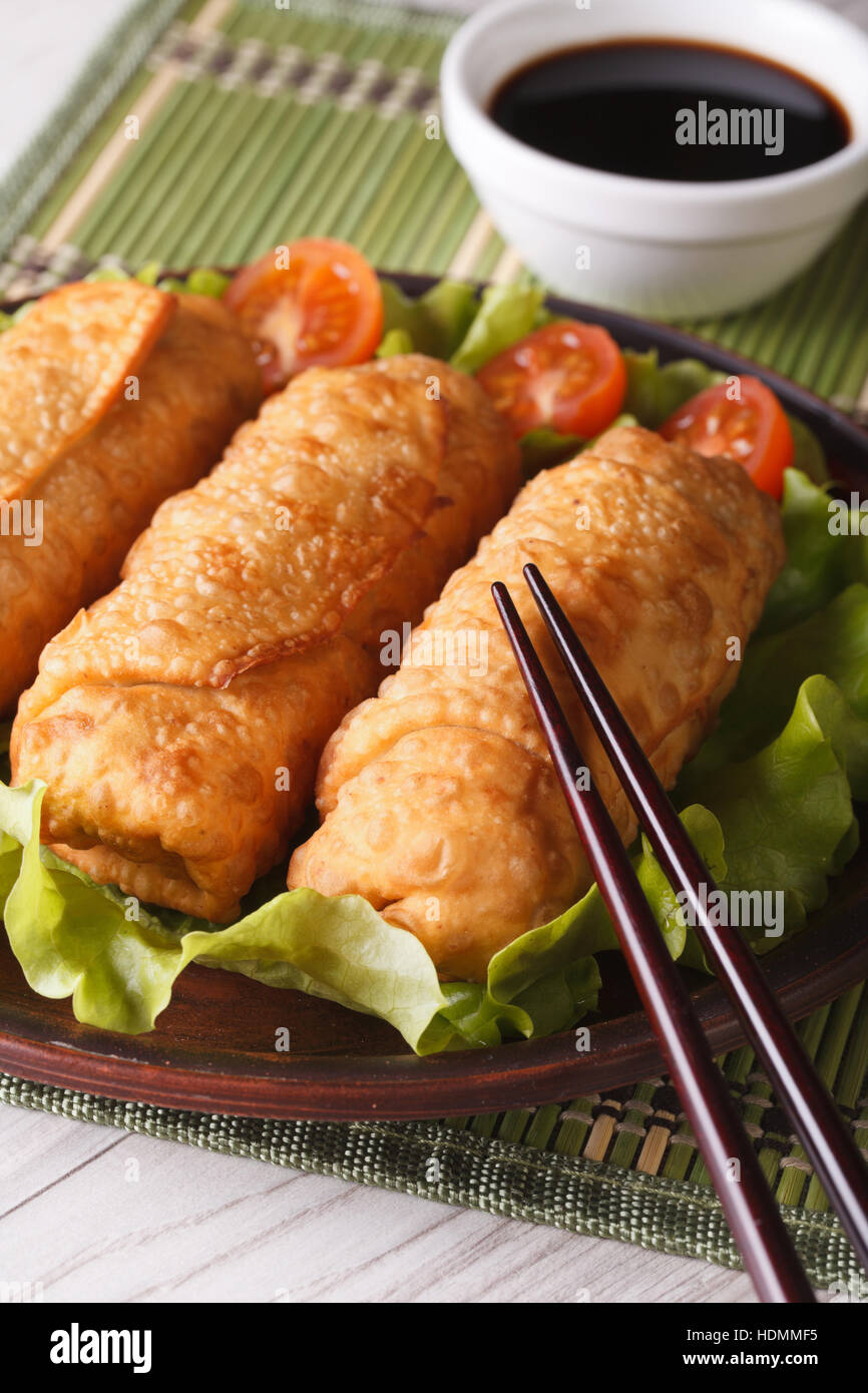 Asian spring rolls fried on a plate close-up and sauce. Vertical Stock ...