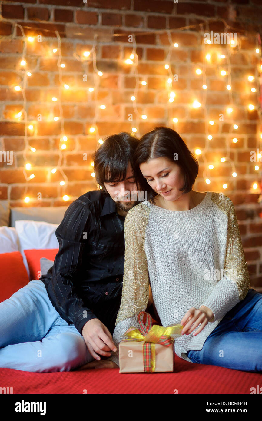 Boxing day. The young couple sits having nestled to each other on a big ...