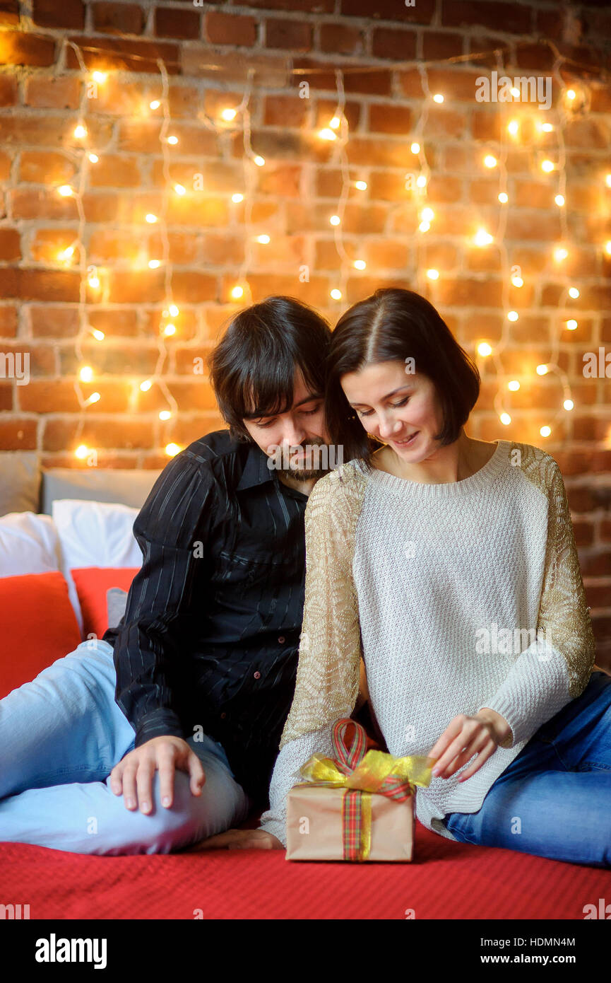 Boxing day. The young couple sits having nestled to each other on a big ...
