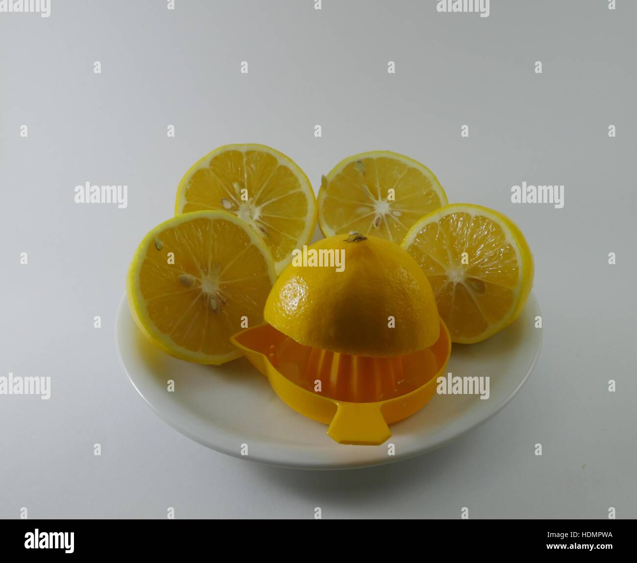 Lemons cut in half ready to be squeezed Stock Photo - Alamy