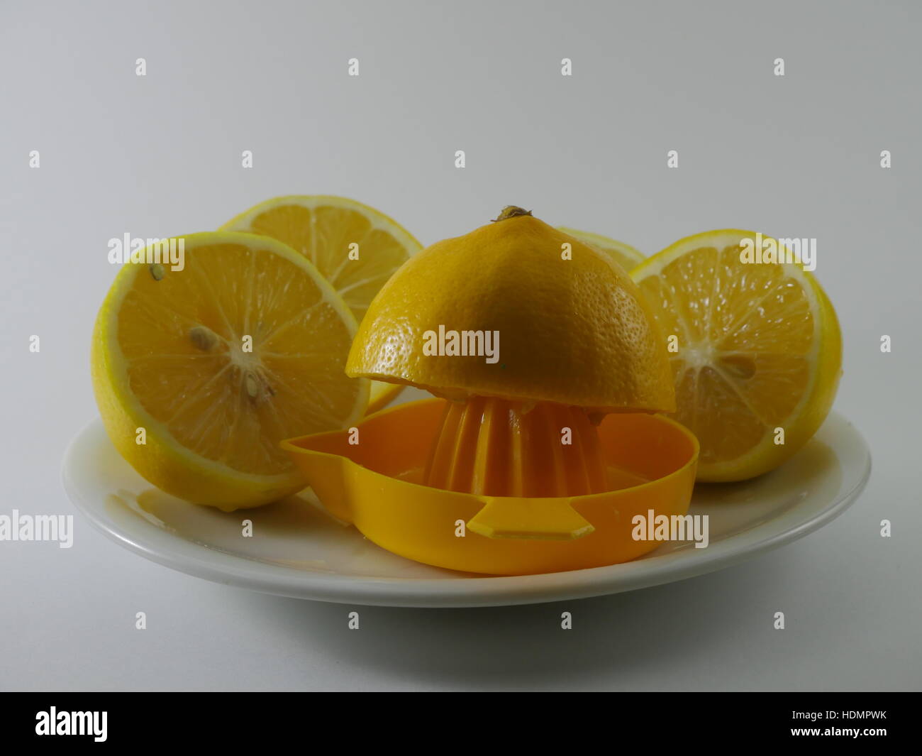 Lemons cut in half ready to be squeezed Stock Photo - Alamy