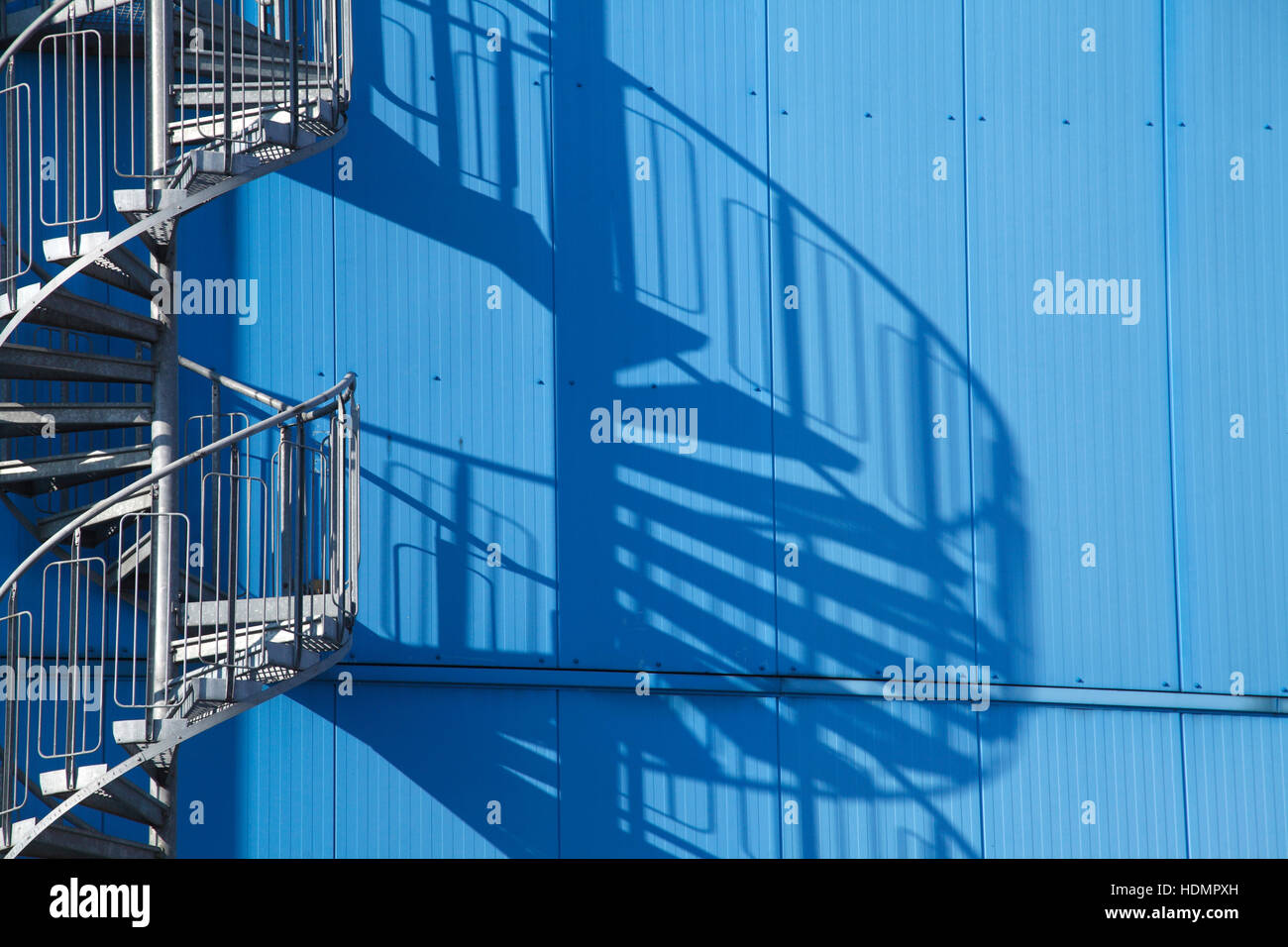 Spiral staircase and shadow on blue factory façade, Bremen, Germany ...