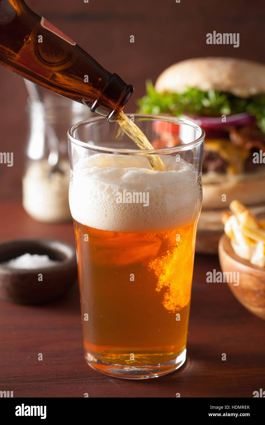 pouring india pale ale beer into pint glass and fastfood Stock Photo ...