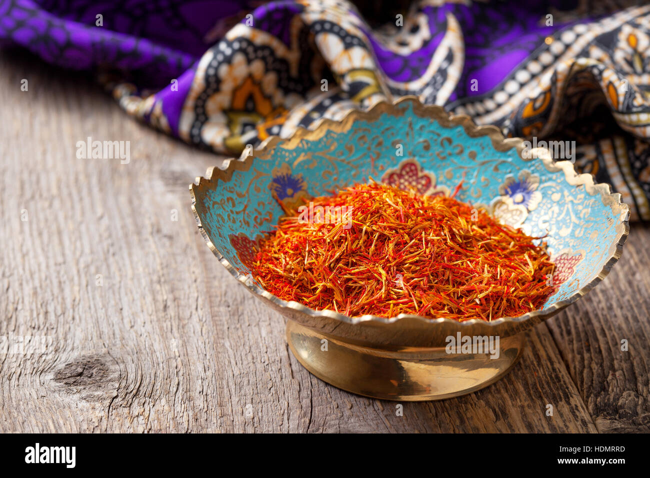 saffron in a metal bowl on the old wooden background Stock Photo - Alamy