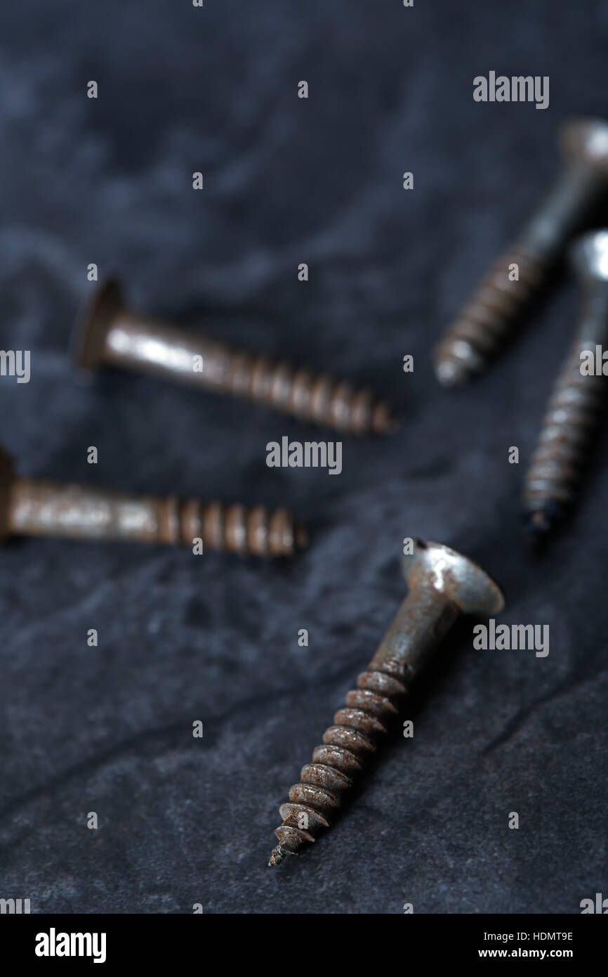 Group of rusty screws. Close-up vertical photo Stock Photo - Alamy