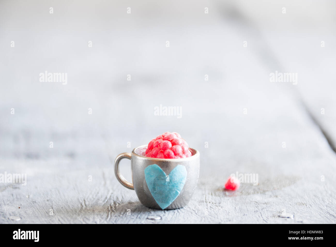 ripe raspberry in a cup with heart, place for text Stock Photo - Alamy
