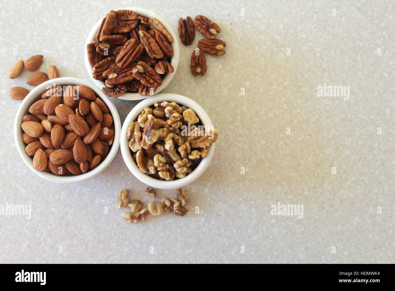 Delicious almonds, pecans, and walnuts in containers on a kitchen ...