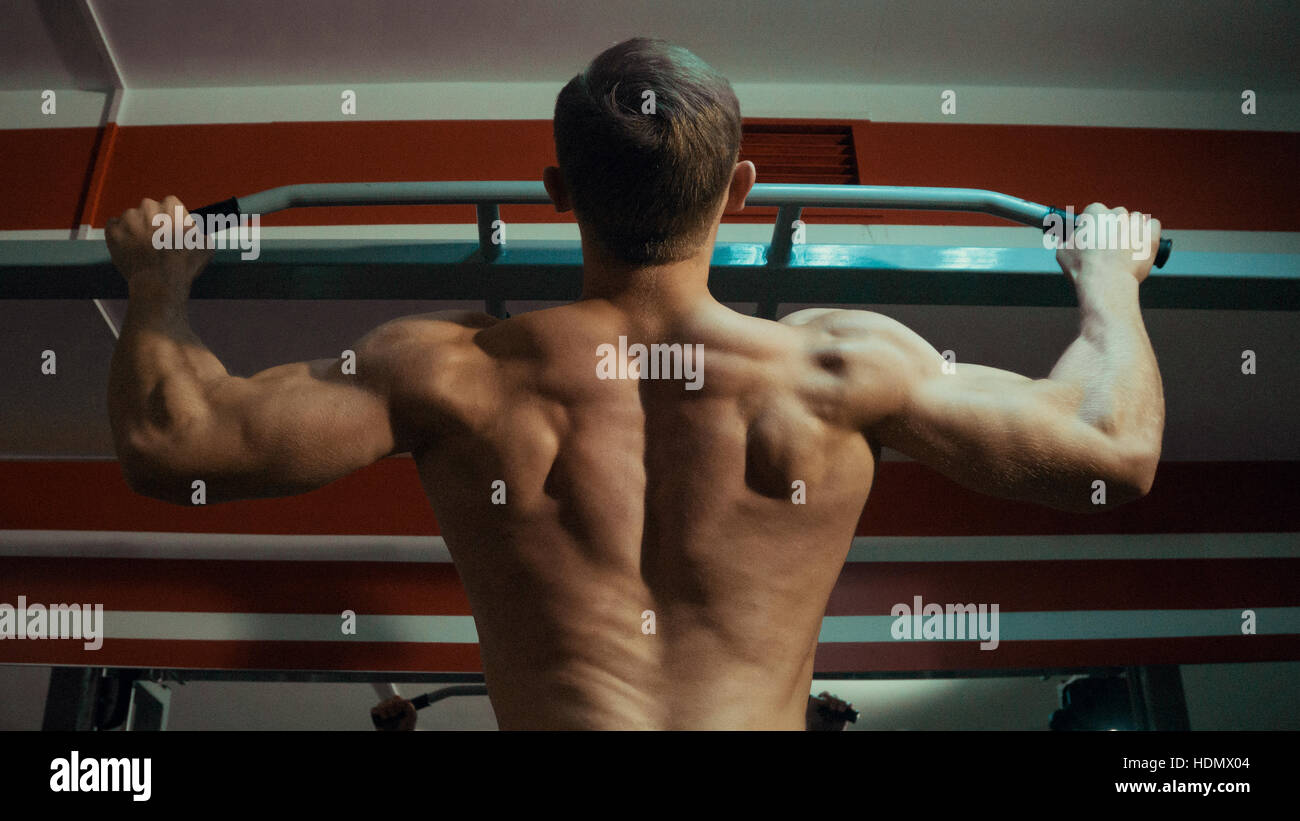 Strong man doing pull-ups in the gym Stock Photo - Alamy