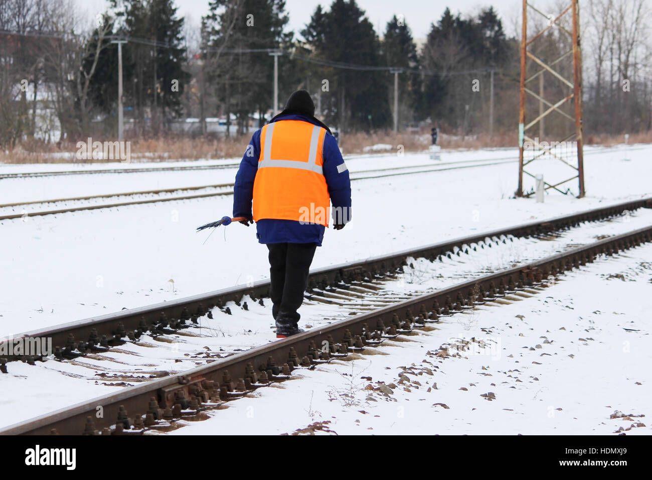railroad worker in orange uniforms walking on the tracks Stock Photo ...