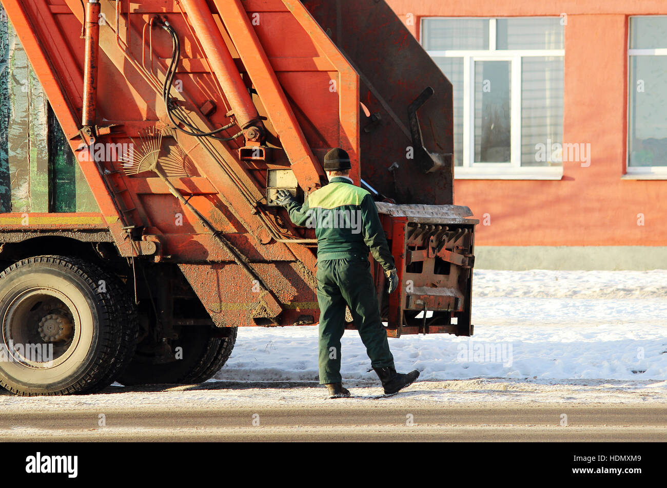 Worker standing next to a junk car after loading garbage tank Stock ...