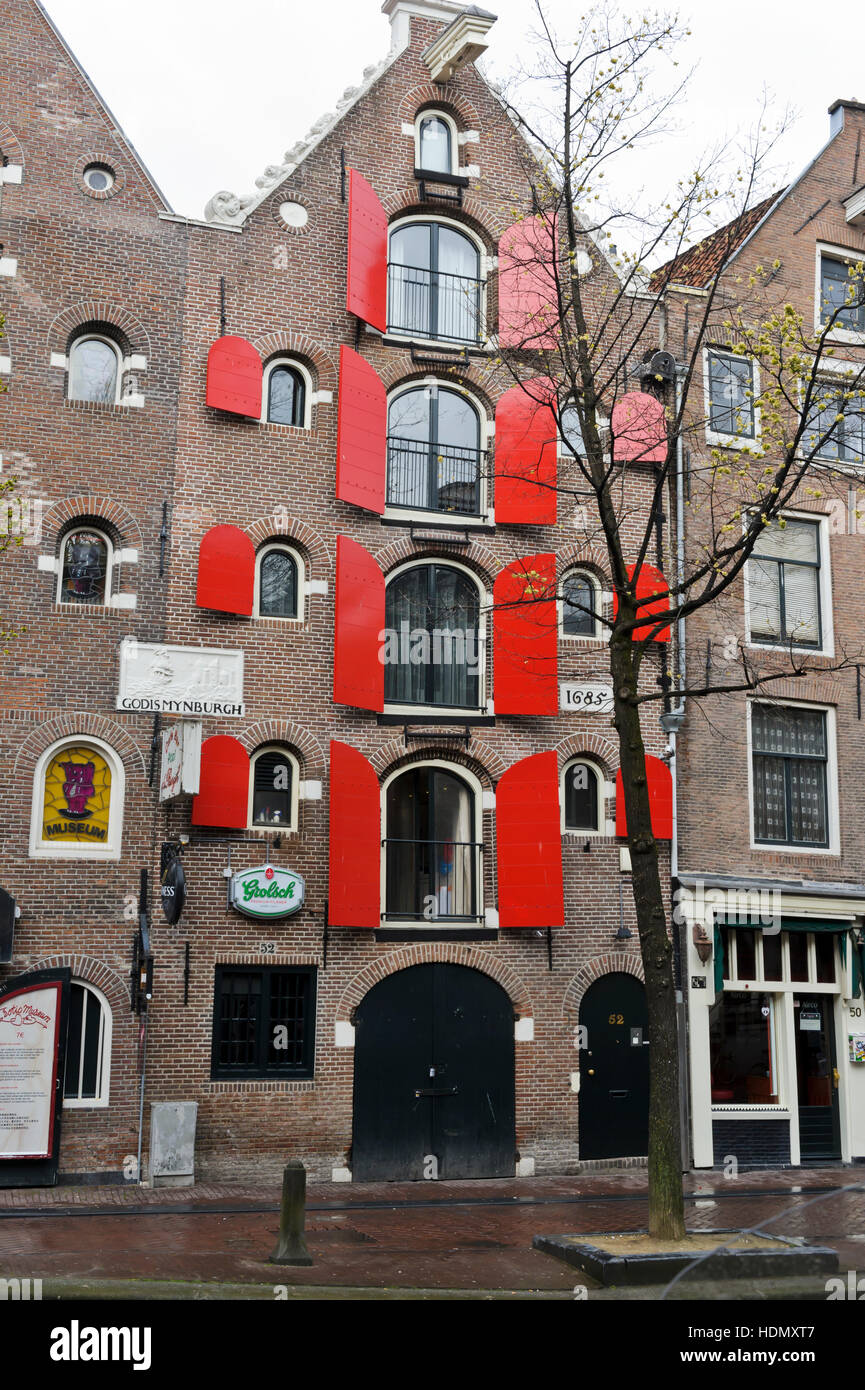 A traditional building with red wooden shutters in Amsterdam, Holland ...