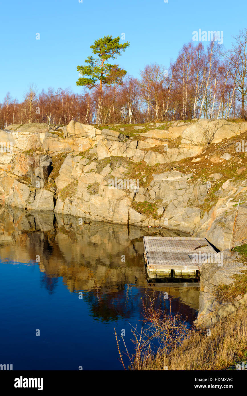 Homemade floating bathing bridge at the steep side of a water filled ...