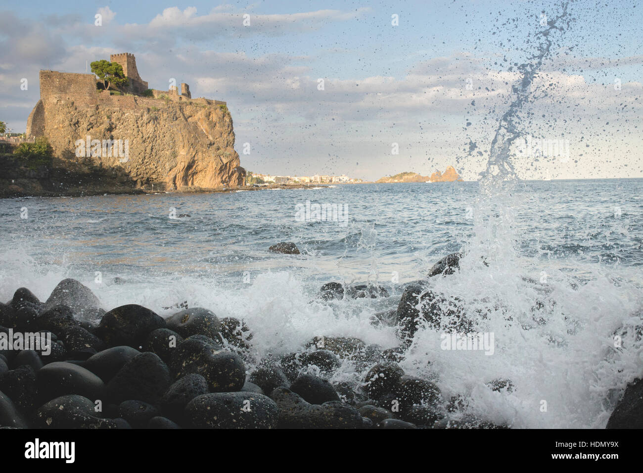 Deep blue sea waves splashing volcanic rocks, Aci Castello in ...