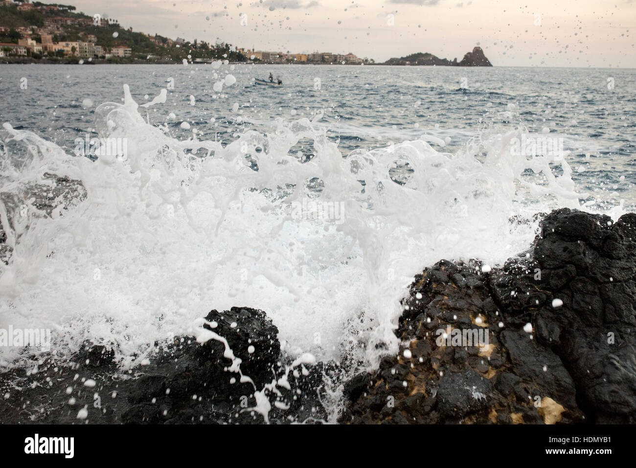 Deep blue sea waves splashing volcanic rocks, Catania, Sicily coast ...