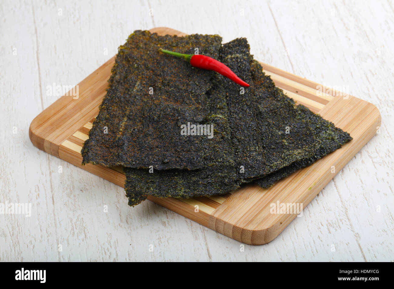 Spicy Nori seaweed sheets with pepper on wood Stock Photo - Alamy