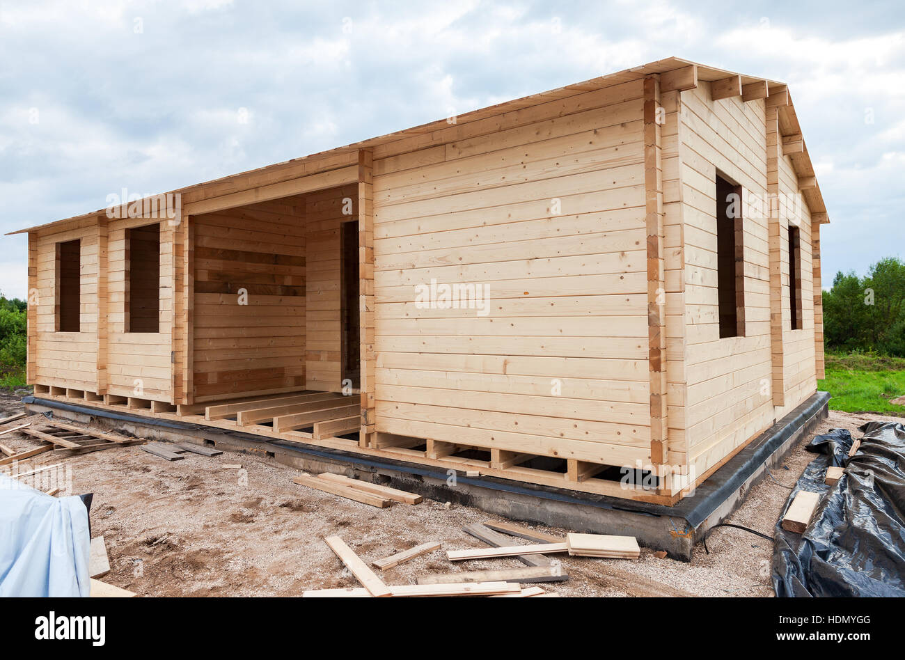 Construction of a new wooden house in summer day Stock Photo - Alamy