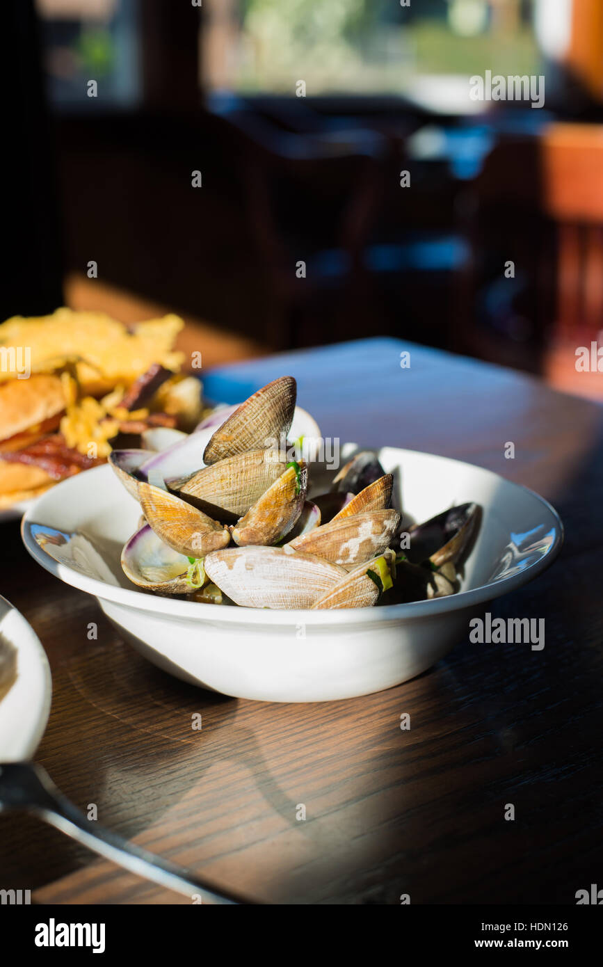 Empty clam shells in a small white bowl Stock Photo - Alamy