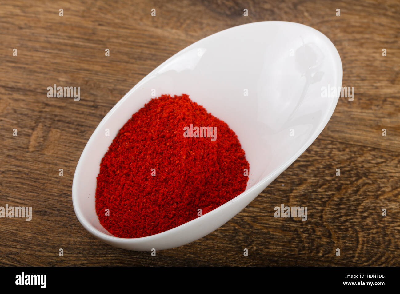 Red pepper powder heap in the bowl over wooden background Stock Photo ...