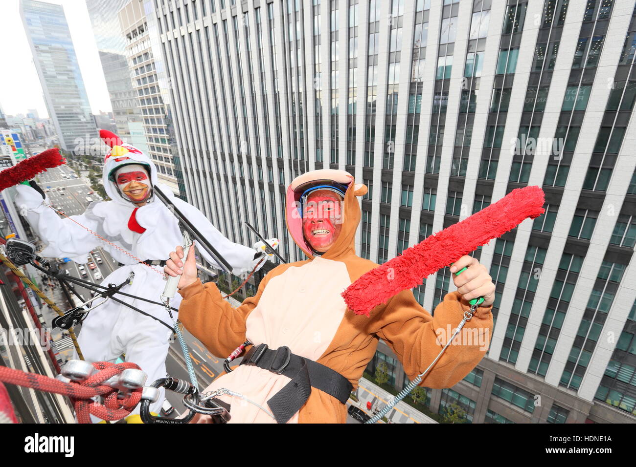 Tokyo, Japan, 15th December, 2016. Window cleaners dressed as rooster ...