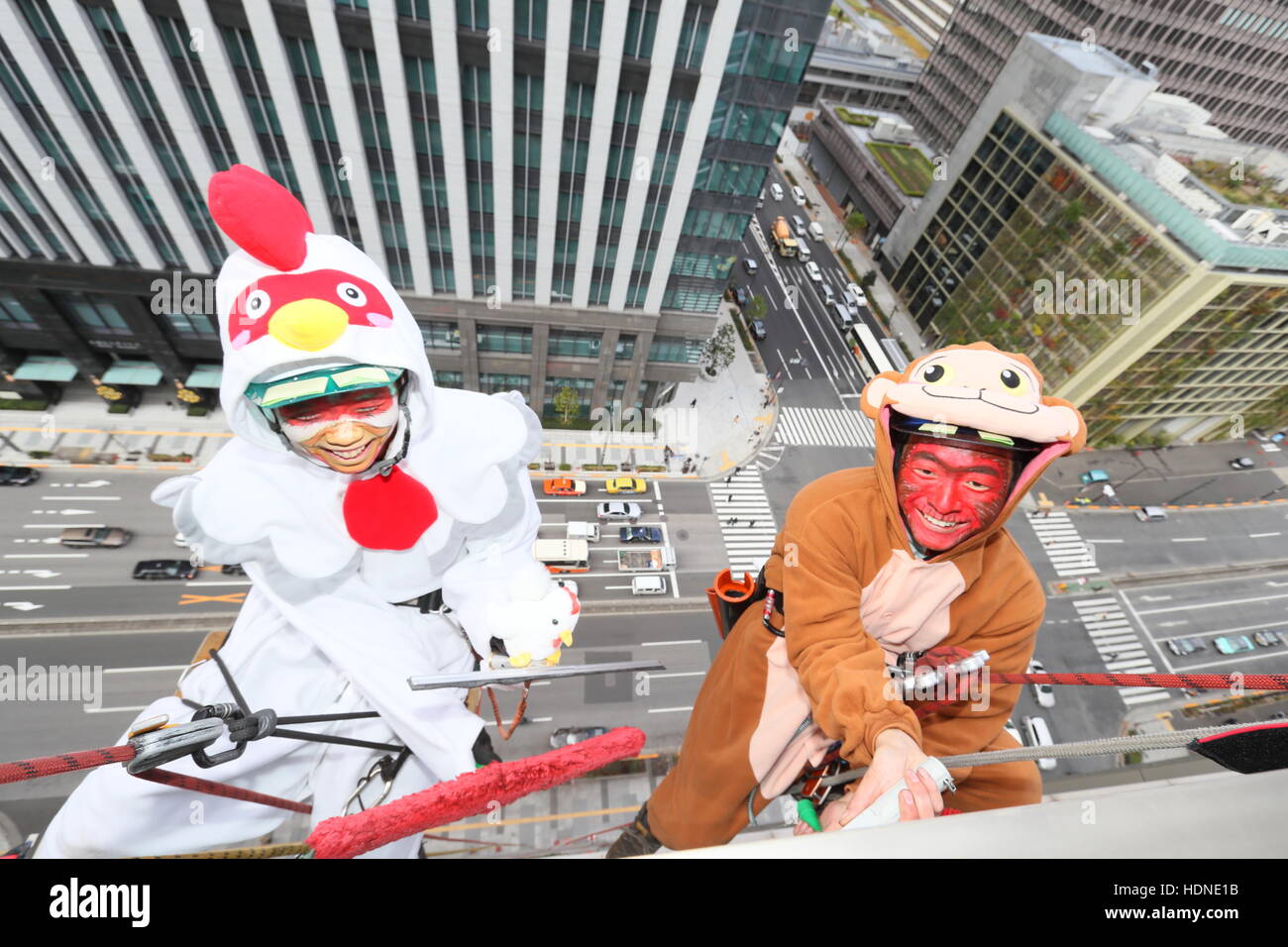 Tokyo, Japan, 15th December, 2016. Window cleaners dressed as rooster ...