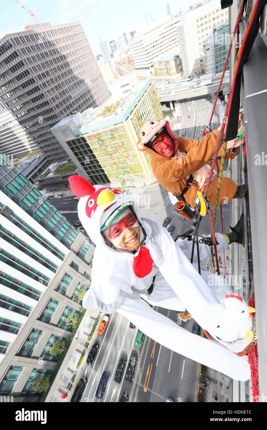 Tokyo, Japan, 15th December, 2016. Window cleaners dressed as rooster ...