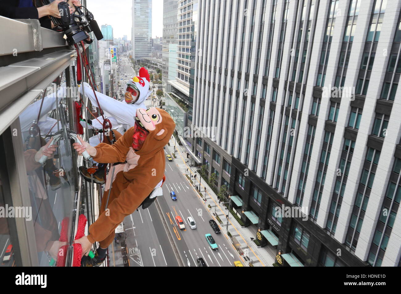 Tokyo, Japan, 15th December, 2016. Window cleaners dressed as rooster ...