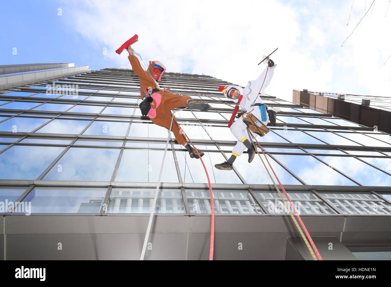 Tokyo, Japan, 15th December, 2016. Window cleaners dressed as rooster ...