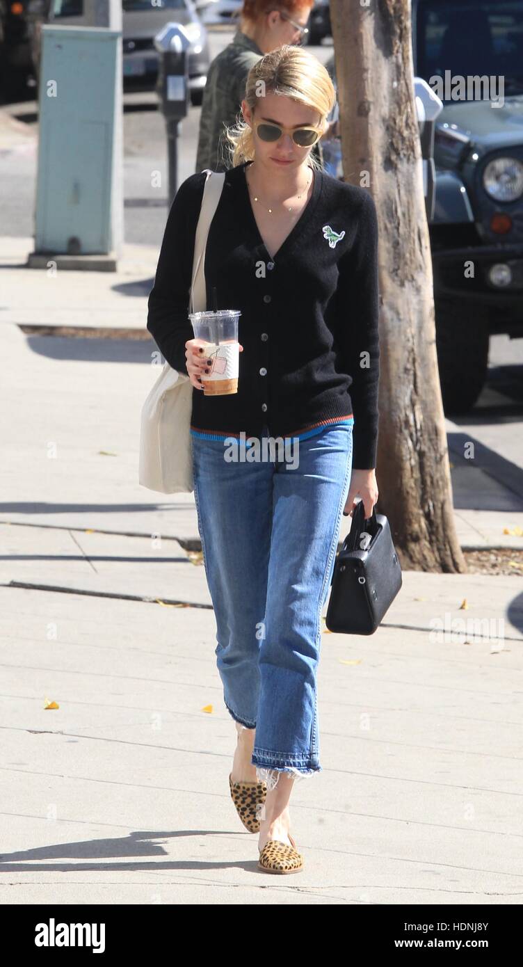 Emma Roberts picks up coffee wearing a black cardigan and cropped denim ...