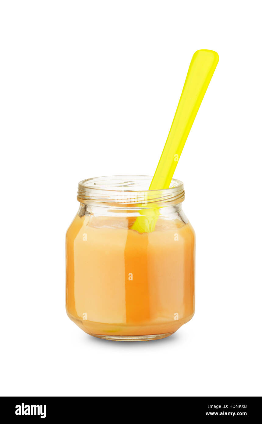 Yellow spoon in jar of baby food isolated on a white background Stock ...