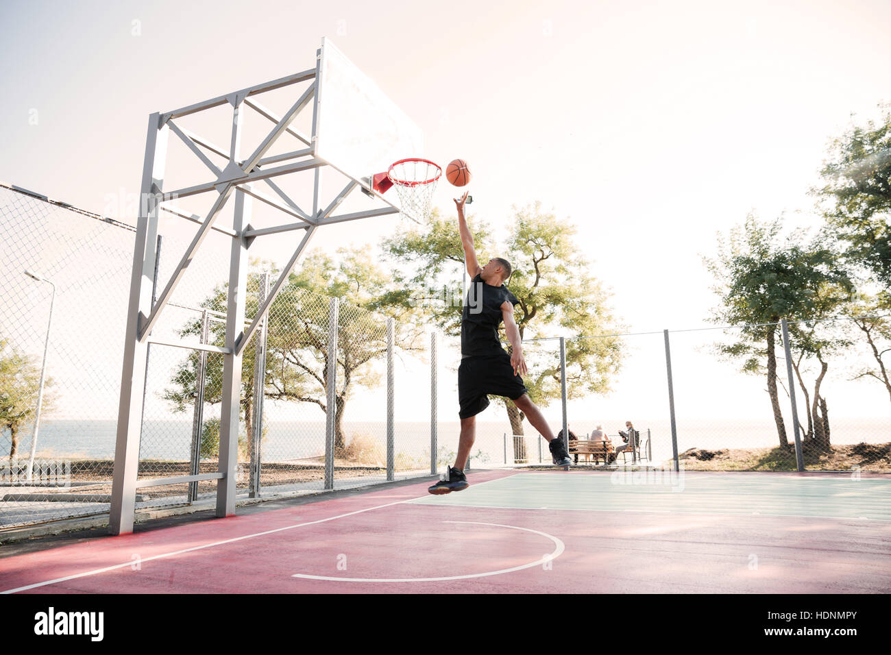 Photo of basketball player practicing and posing for basketball and ...