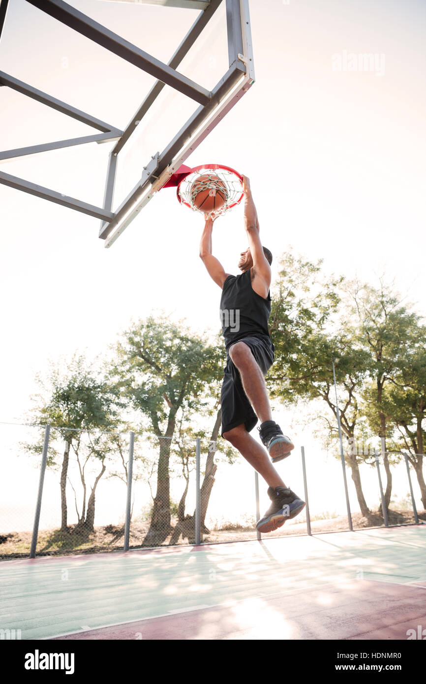 Picture of basketball player practicing for basketball. Looking at ...
