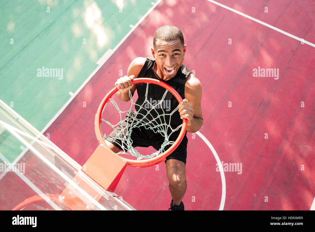 Image of young screaming african basketball player practicing. Looking ...