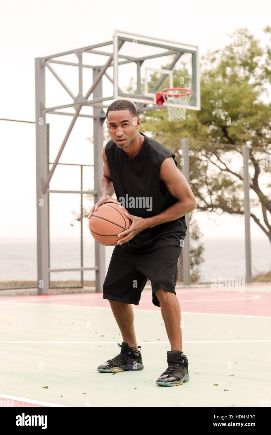 Image of young attractive african basketball player practicing in the ...