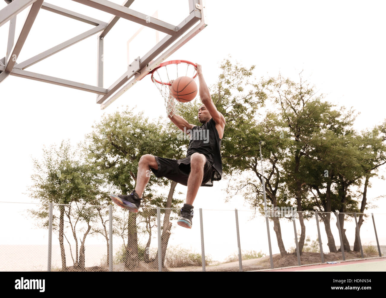 Picture of basketball player practicing for basketball and jumping to ...