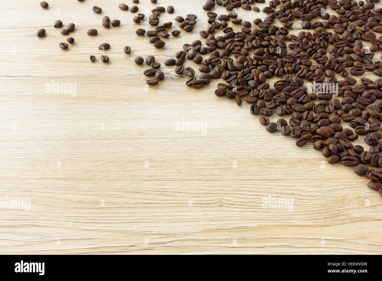 Fresh roasted coffee beans spread out on wooden background Stock Photo ...