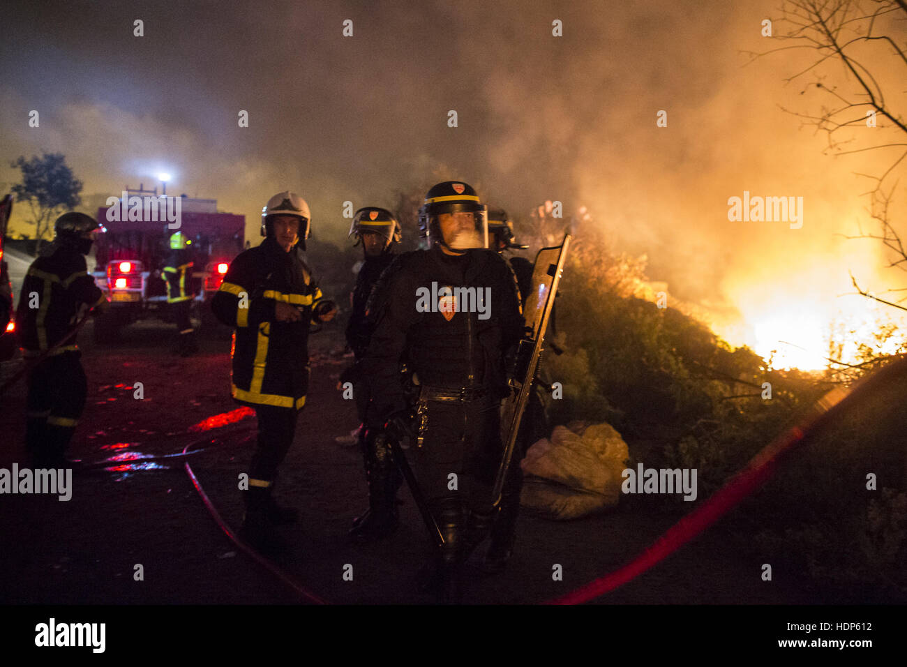 Firefighters in the Calais Jungle putting out fires set alight by ... Firefighters in the Calais Jungle putting out fires set alight by ...