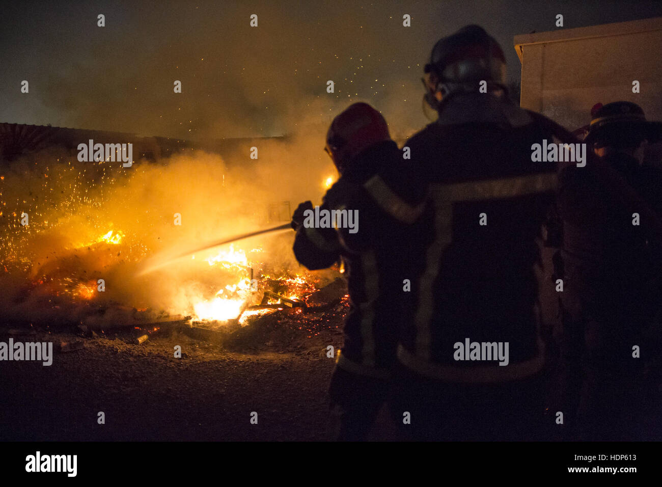 Firefighters in the Calais Jungle putting out fires set alight by ... Firefighters in the Calais Jungle putting out fires set alight by ...