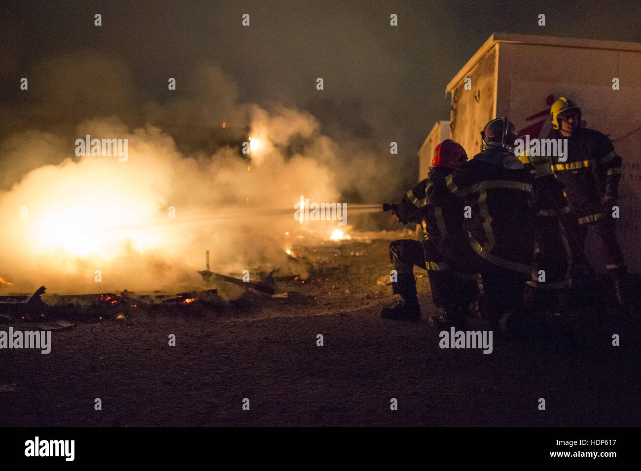 Firefighters in the Calais Jungle putting out fires set alight by ... Firefighters in the Calais Jungle putting out fires set alight by ...