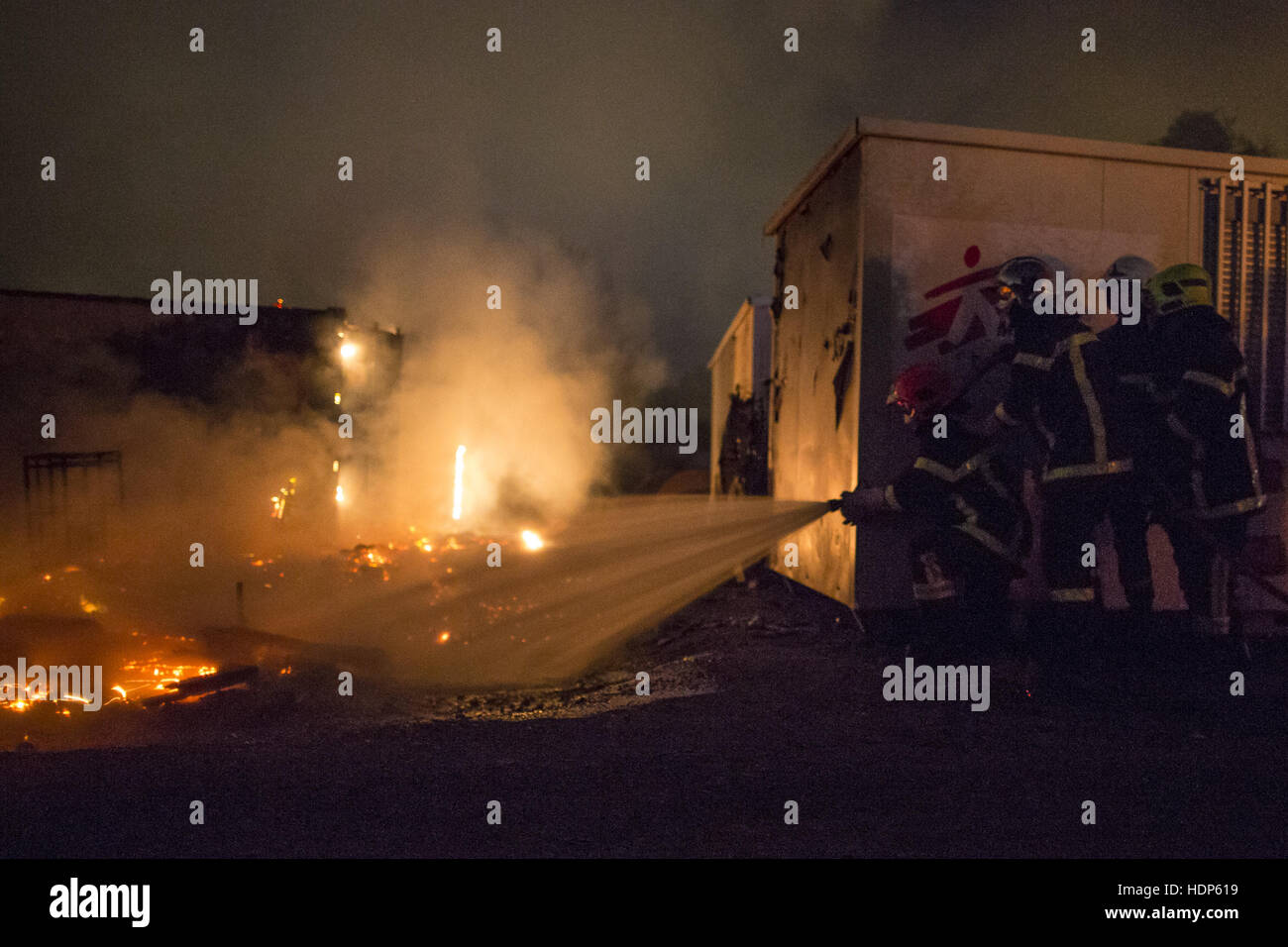Firefighters in the Calais Jungle putting out fires set alight by ... Firefighters in the Calais Jungle putting out fires set alight by ...