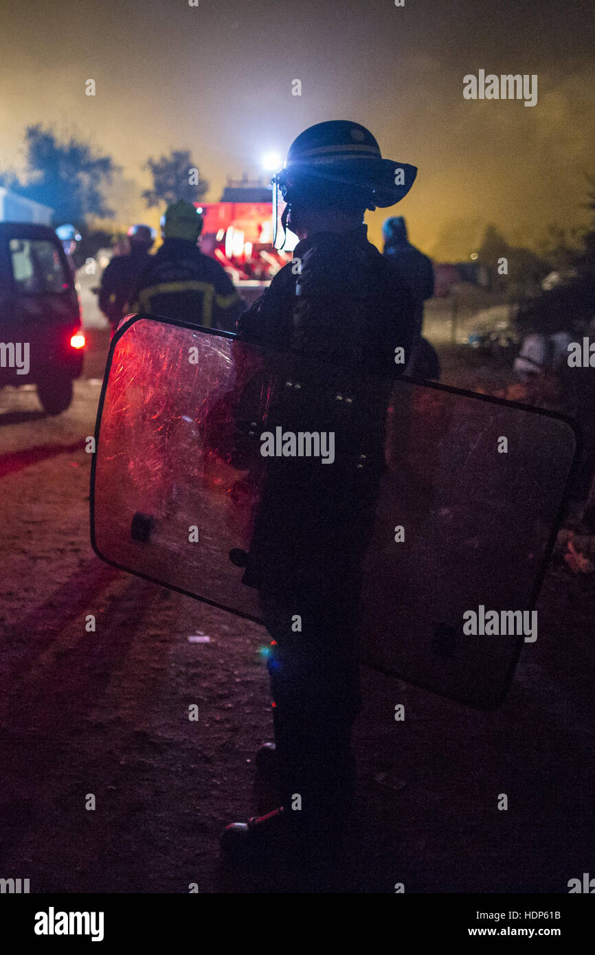 Firefighters in the Calais Jungle putting out fires set alight by ...