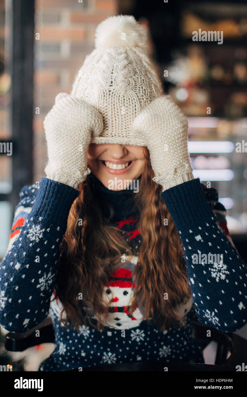 beautiful girl in sweater with snowmen pulled a cap over eyes Stock ...