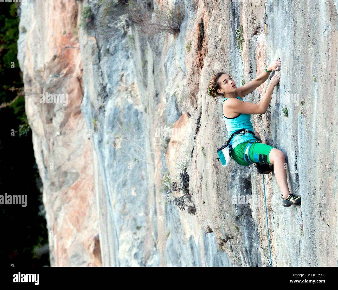 Portrait of Junior Female Athlete tenaciously hanging on Wall Stock ...