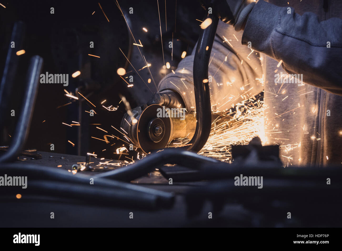 Metal grinding on steel pipe with flash of sparks close up Stock Photo ...