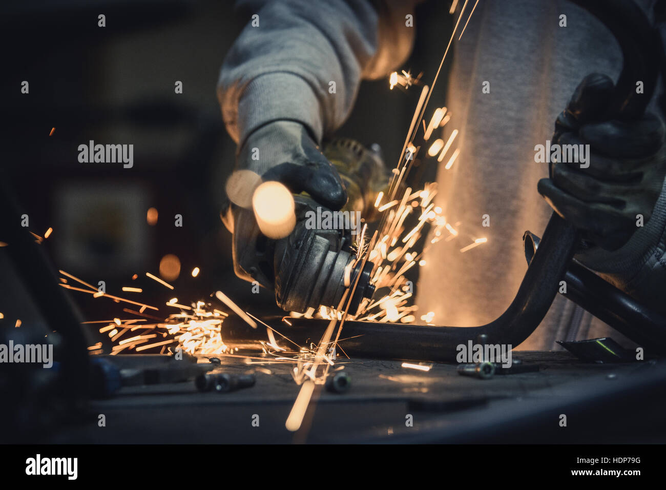 Grinding metal pipe in a workshop and sparks flying Stock Photo - Alamy