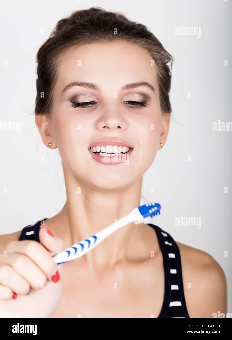 Close-up of a young woman is brushing her teeth. Dental health care ...