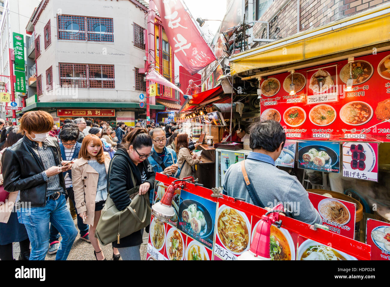 Japan, Kobe, Nankinmachi, Chinatown. People queueing at outdoor popular ...