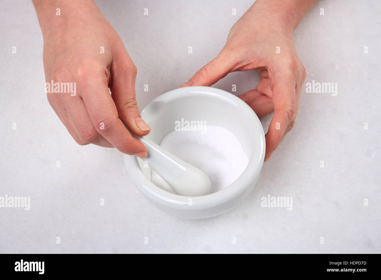 hands crushing on mortar with pestle Stock Photo - Alamy