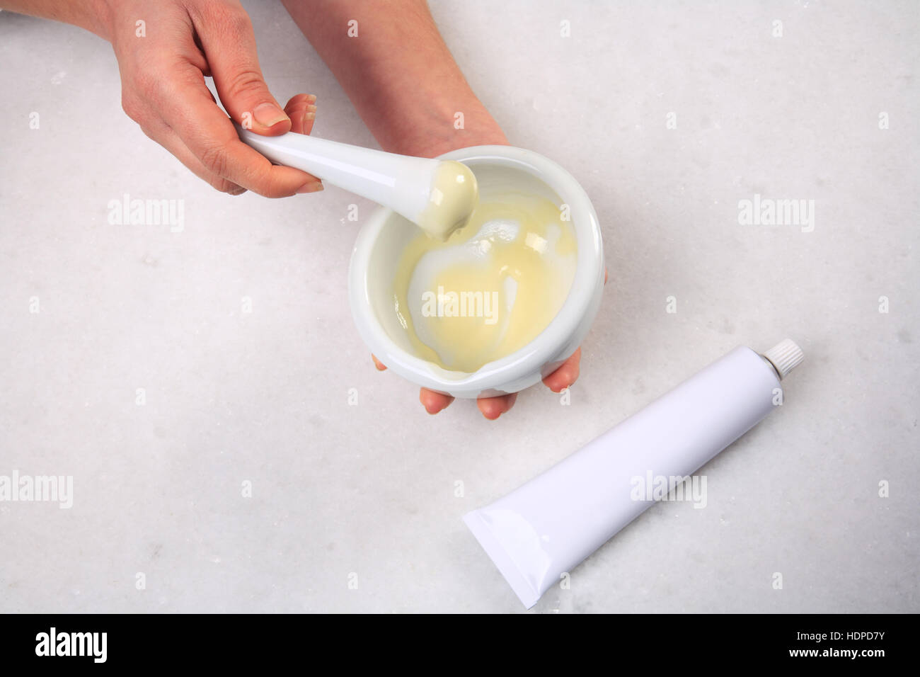 hands mixing ingredients on mortar to make cream Stock Photo - Alamy
