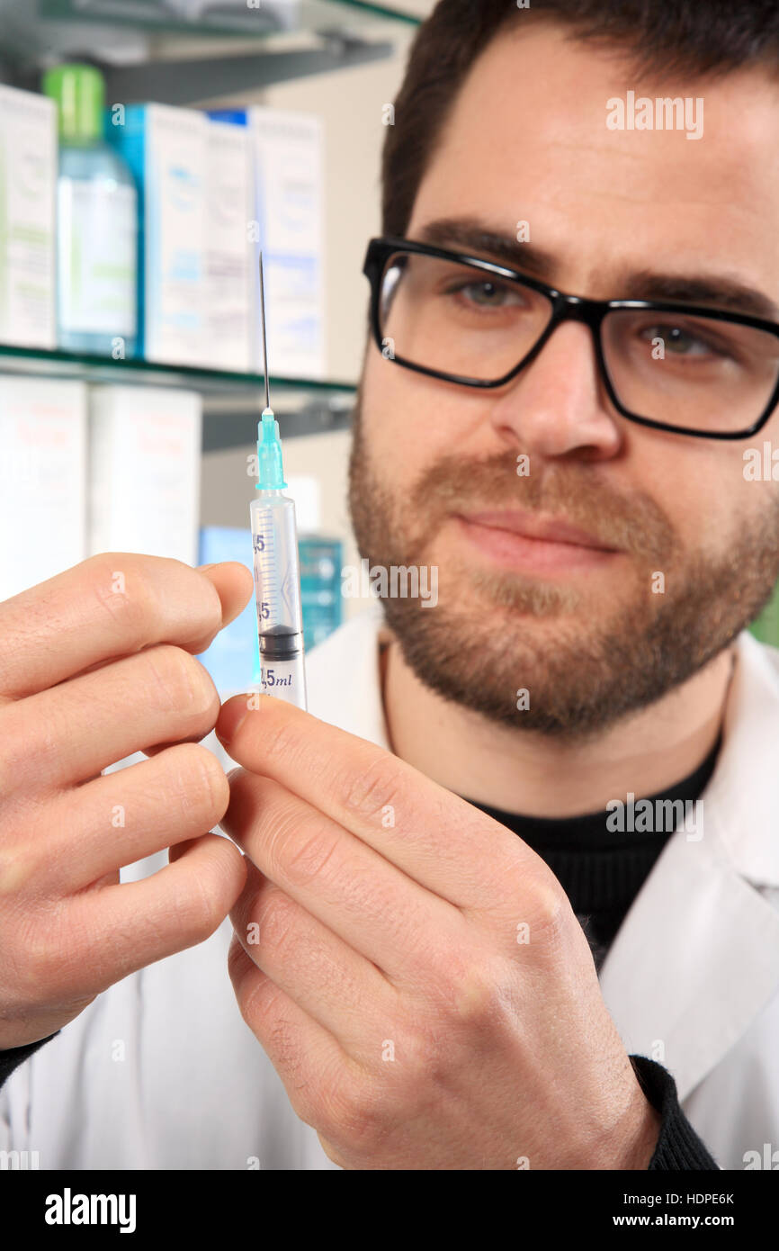 young male pharmacist holding an injection Stock Photo - Alamy